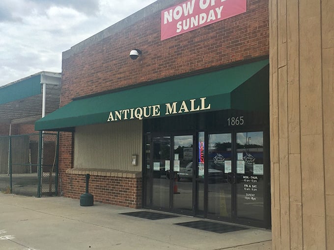 "Now Open Sunday" – Heritage Square tempts weekend treasure hunters with its green awning and promise of discoveries.