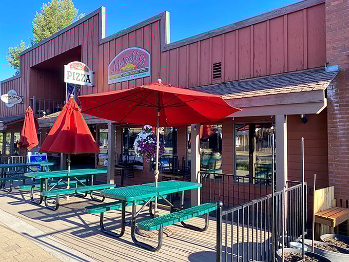 Those cheerful red umbrellas aren't just for show—they're sheltering some of the happiest pizza moments in central Oregon.
