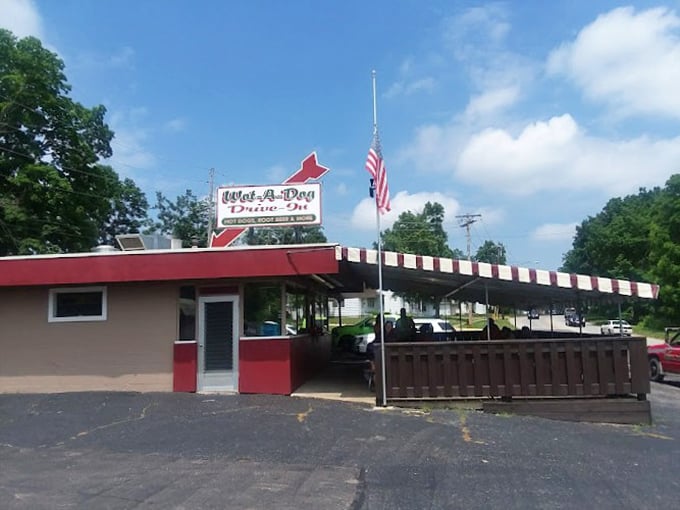 The striped awning isn't just for shade—it's a colorful salute to simpler times when dinner came with a side of fresh air.