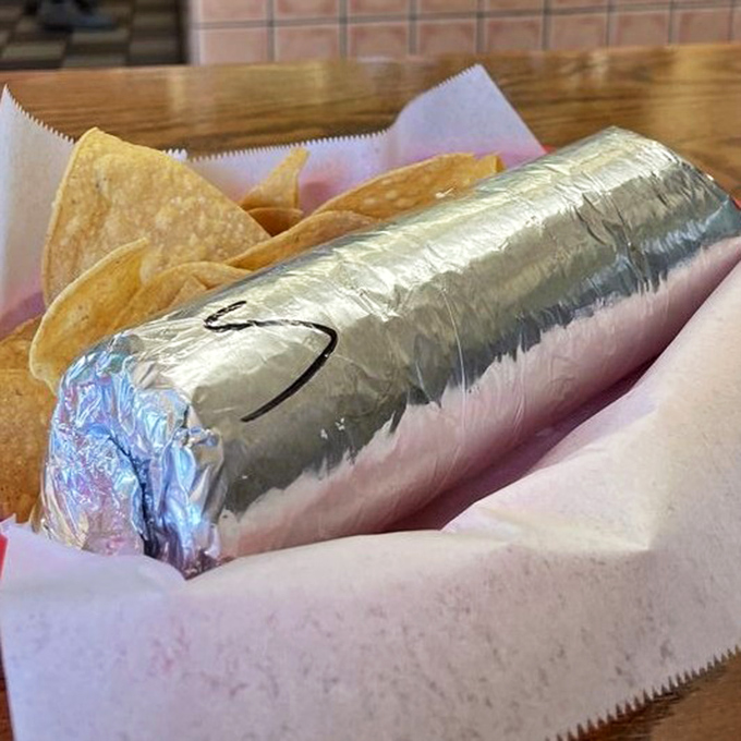 The silver-wrapped burrito—like a present your stomach has been waiting for all day. The chips are just the bow on top.
