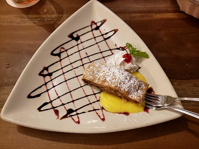 Apple strudel that deserves its own passport. Flaky pastry, warm apples, and that artistic drizzle of sauce—dessert diplomacy at its finest.