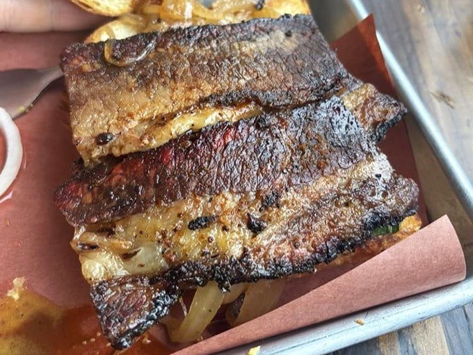 The brisket sandwich isn't messing around. That bark, that tenderness, that perfect ratio of meat to bread—it's architecture you can eat.
