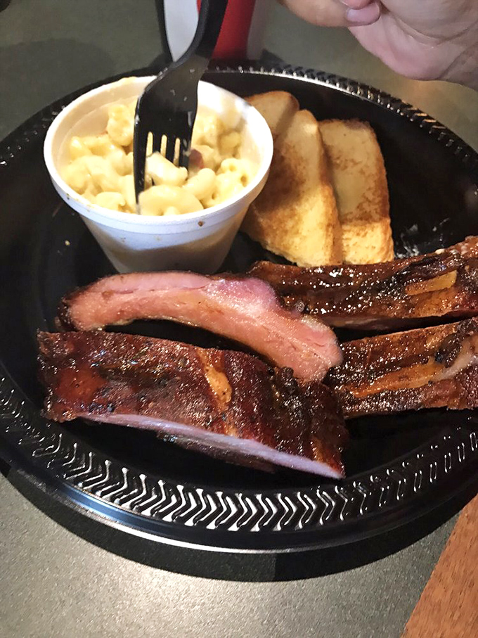 These ribs have that perfect pink smoke ring that separates the barbecue masters from the pretenders. The mac and cheese isn't just a side – it's a co-star.