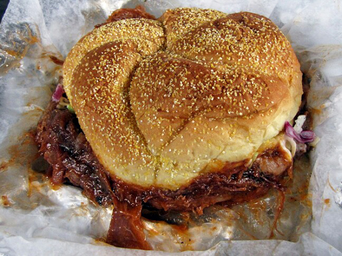 This BBQ sandwich isn't trying to impress anyone with fancy presentation—it's too busy being absolutely delicious.