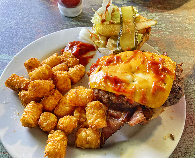This isn't just a burger—it's an architectural masterpiece of beef, cheese, and tater tots that makes you question why anyone would eat anything else.