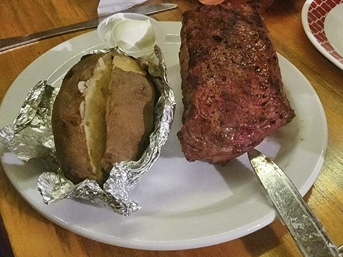 The humble baked potato, elevated to art form. Wrapped in foil like a silver present, it's the perfect sidekick to that magnificent steak.