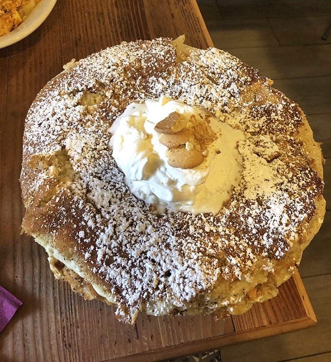 This isn't just a pancake – it's a structural engineering marvel with whipped cream architecture that defies both gravity and restraint.