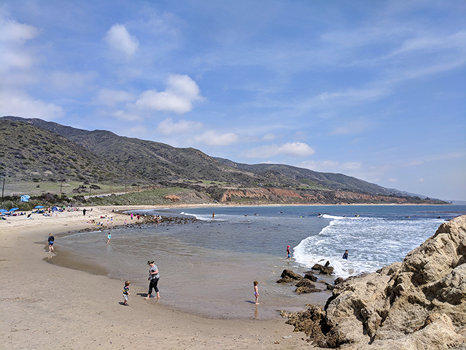 Family beach day in action – where kids build sandcastles while parents build memories that will outlast any office achievement.