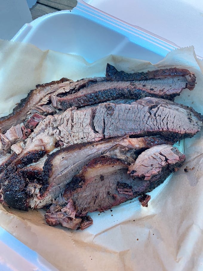 Behold the brisket in all its glory—that smoke ring is like nature's way of drawing a bullseye around perfection. 