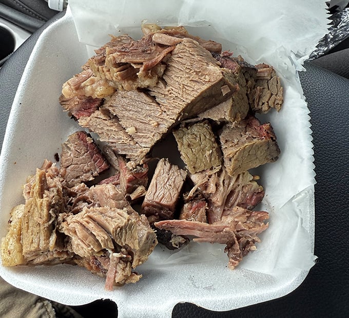 Brisket that doesn't need Instagram filters—just look at that perfect pink smoke ring and bark that took hours to develop.