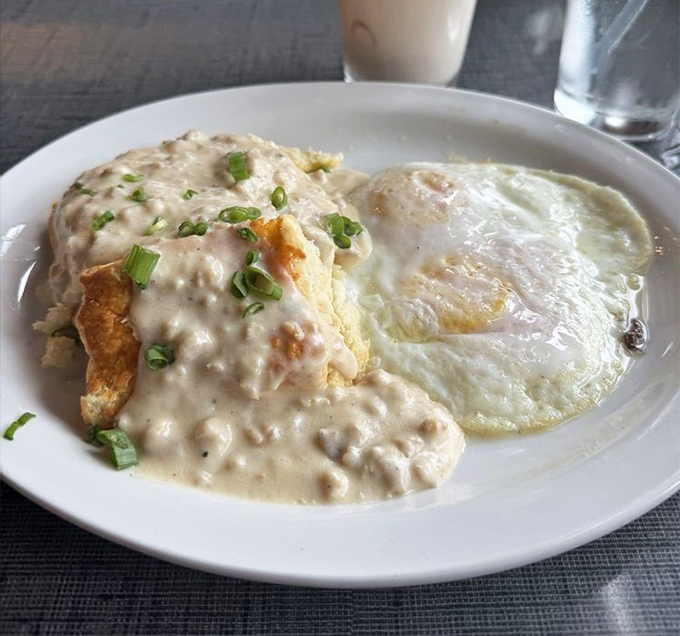 Biscuits drowning happily in creamy sausage gravy—the breakfast equivalent of a warm hug from your favorite aunt.