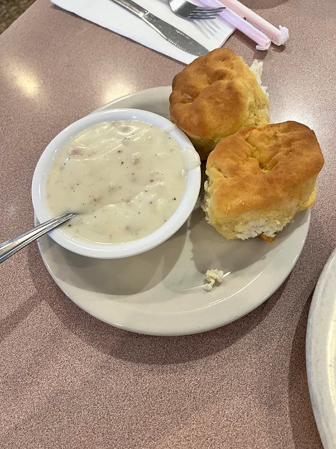 These biscuits don't just rise—they ascend to a higher plane of existence, especially when baptized in that pepper-flecked gravy.