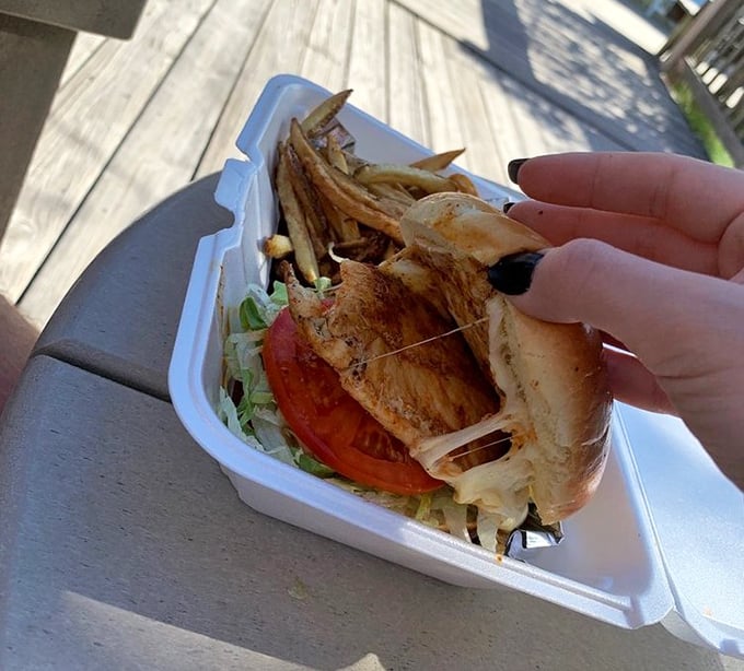 The blackened chicken sandwich arrives looking like it means business – and trust me, it absolutely does.