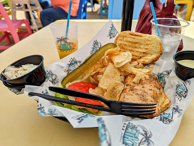 The blackened Mahi sandwich arrives like a postcard from paradise—fish so fresh it practically introduces itself before melting into that perfectly toasted bun.