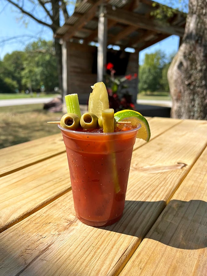 This Bloody Mary isn't just a drink—it's a garden party in a cup, complete with olives standing at attention like they're guarding liquid treasure.