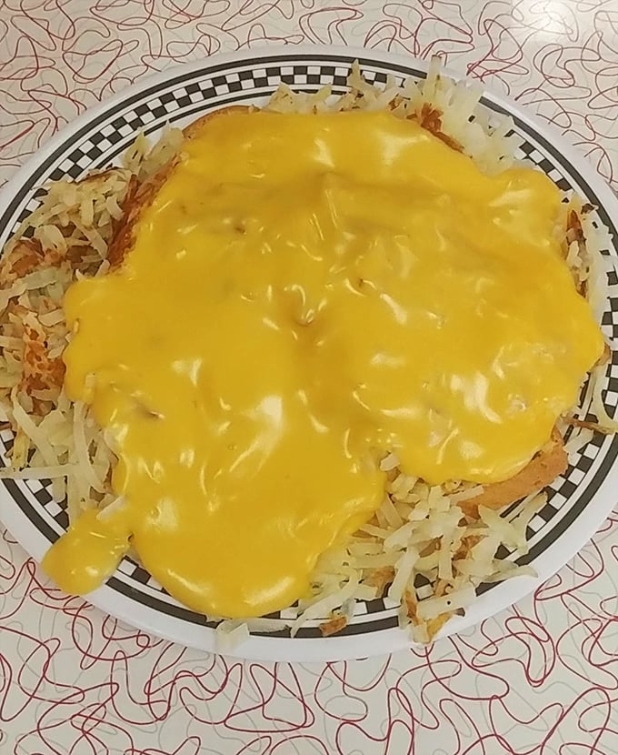 Springfield's legendary horseshoe in all its cheese-drenched glory – where toast, meat, and fries unite under a molten yellow canopy of pure indulgence.