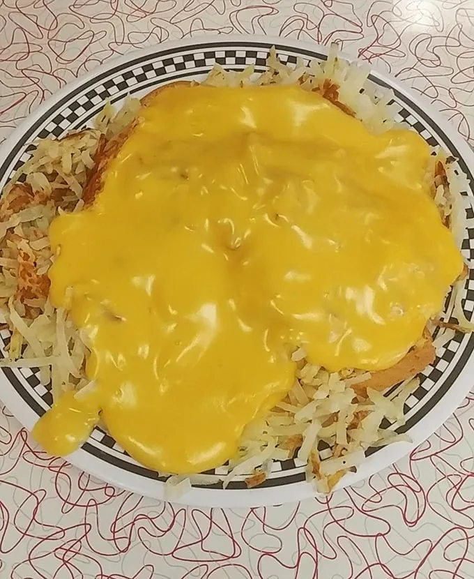 Springfield's legendary horseshoe in all its cheese-drenched glory – where toast, meat, and fries unite under a molten yellow canopy of pure indulgence.