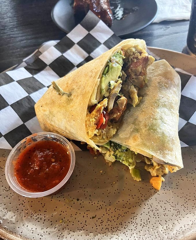 
This breakfast burrito isn't messing around. Packed with colorful ingredients and served with salsa, it's a morning fiesta worth waking up for. 