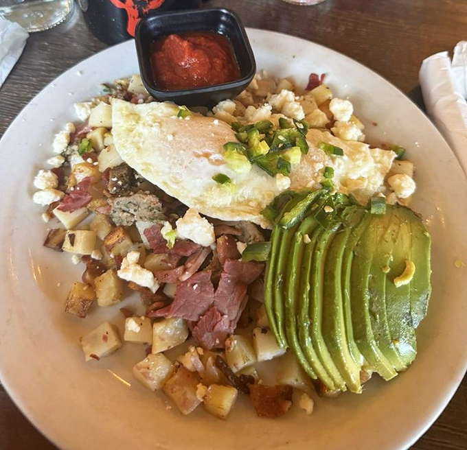Breakfast alchemy at its finest—crispy potatoes, perfectly cooked eggs, and avocado sliced with the precision of a Swiss watchmaker.