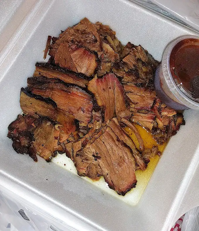 Brisket that speaks the universal language of smoke and time. No translator needed – just napkins. Lots of napkins.
