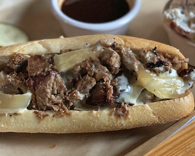 This brisket sandwich isn't just food—it's architecture. The melted cheese acts as delicious mortar holding together the temple of flavor.