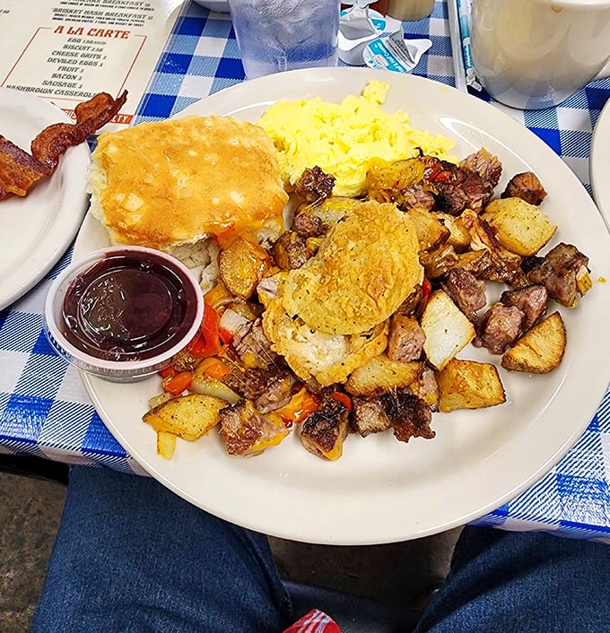 Breakfast alchemy: crispy potatoes, savory meat, and golden eggs sharing a plate like old friends at a reunion.