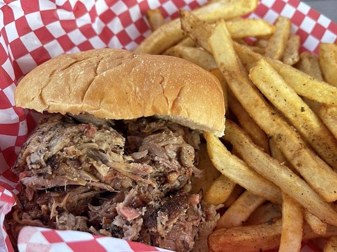 A pulled pork sandwich that doesn't just satisfy hunger—it resolves it completely, with meat so tender it practically surrenders to your bite.