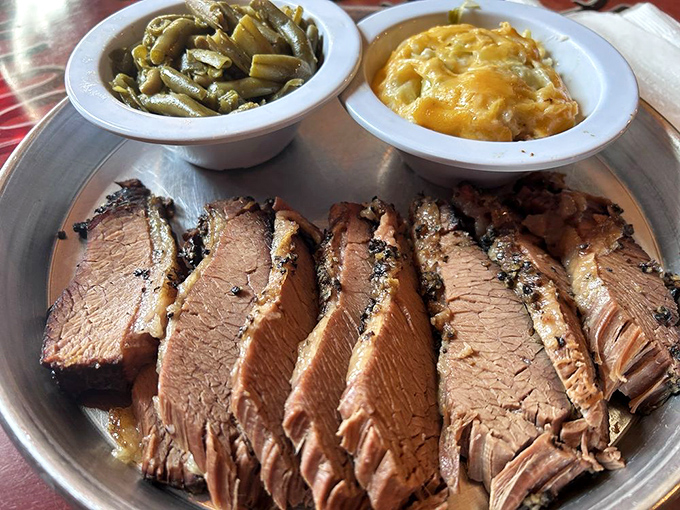 Brisket sliced so perfectly it could make a Texas pitmaster weep with joy. Those sides aren't playing backup—they're co-headlining this delicious show.
