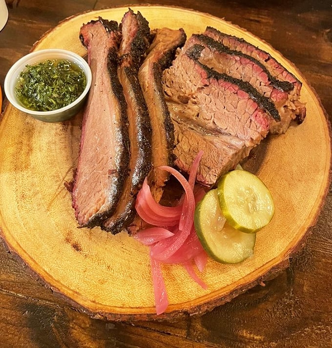 Brisket with that telltale pink smoke ring, the BBQ equivalent of a Rolex. Those pickled onions and cucumbers cut through the richness like witty banter.