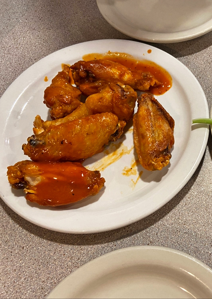 Buffalo wings that don't mess around. That sauce isn't just clinging to the chicken; it's made a lifetime commitment. Napkins required, regrets impossible.