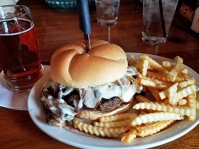 This isn't just a burger—it's an architectural marvel of mushrooms and melted cheese that requires both hands, several napkins, and absolutely zero shame.