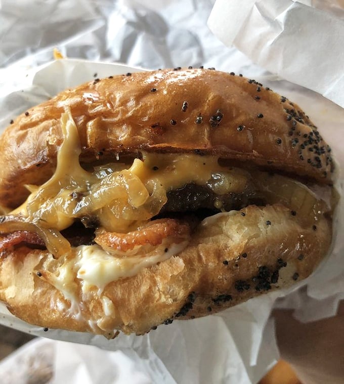 Grilled onions cascading over melted cheese and beef—this isn't just a burger, it's a symphony of flavors conducted by decades of drive-in expertise.