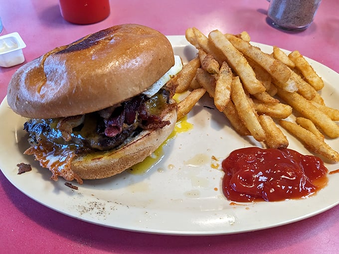 The burger arrives like a delicious dare—juicy, messy, and demanding your full attention. Diet plans have met their worthy nemesis.