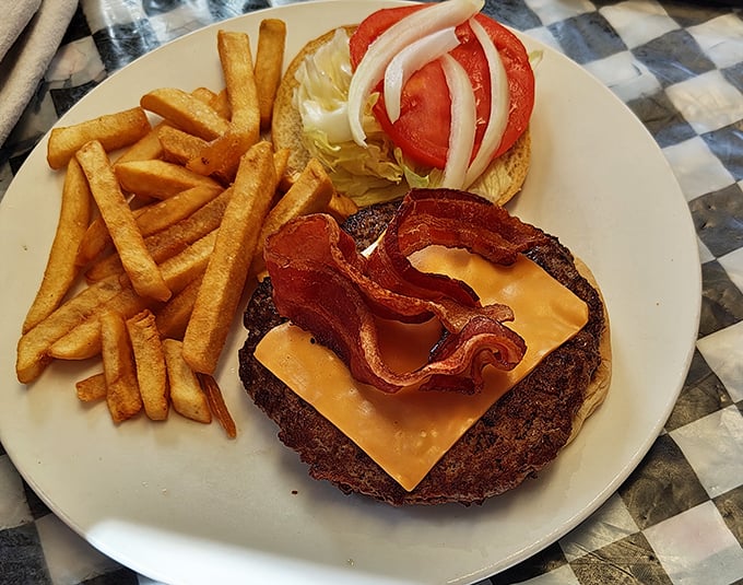 This isn't just a burger – it's architecture. Crispy bacon, melty cheese, fresh veggies, and a substantial patty create the Taj Mahal of lunch options.