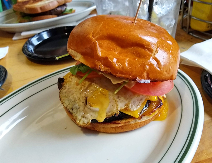 This burger isn't just photogenic – it's a masterclass in construction with that perfectly melted cheese cascading down the sides.
