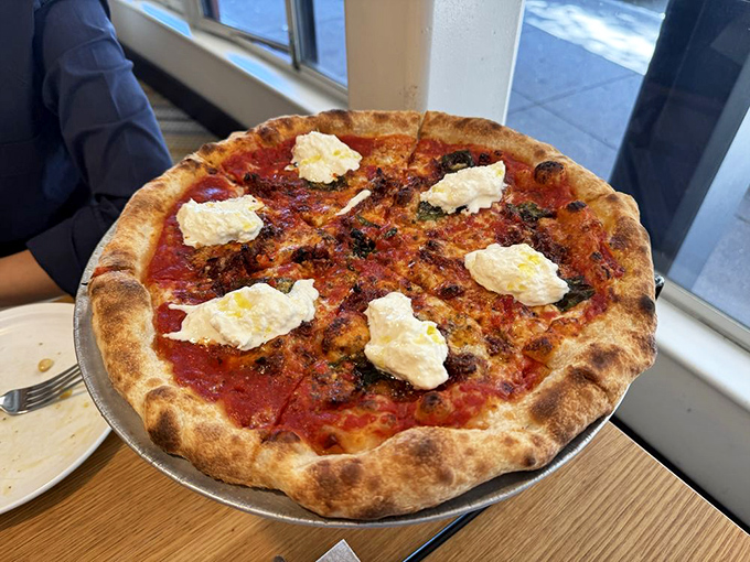 Pizza perfection with pillowy burrata that melts into a dream. The kind of pie that makes you question all other pizza relationships you've had.