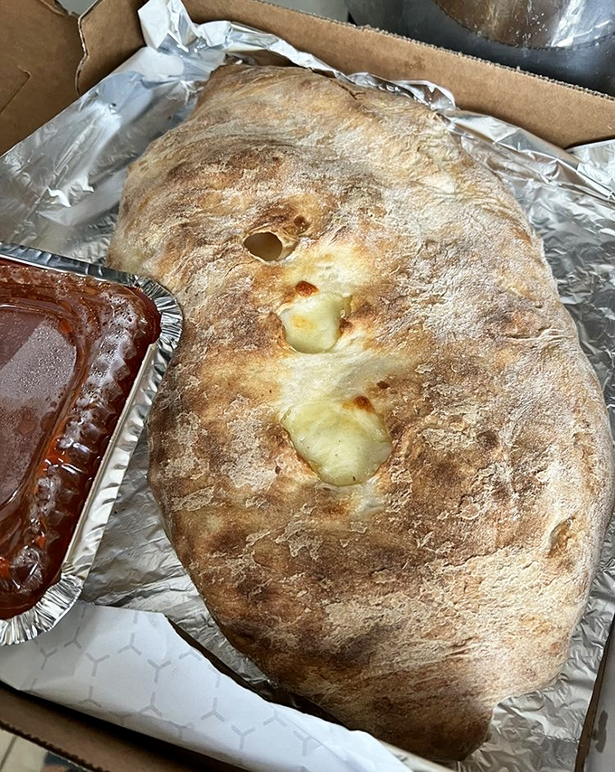 The calzone at Fiori's isn't just a meal—it's an event. This golden-brown behemoth could feed a family or one very determined Pennsylvanian.
