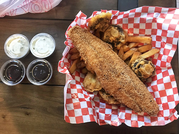 Cornmeal-crusted catfish that would make Mississippi jealous. Served on classic red-checkered paper – because some traditions are sacred.