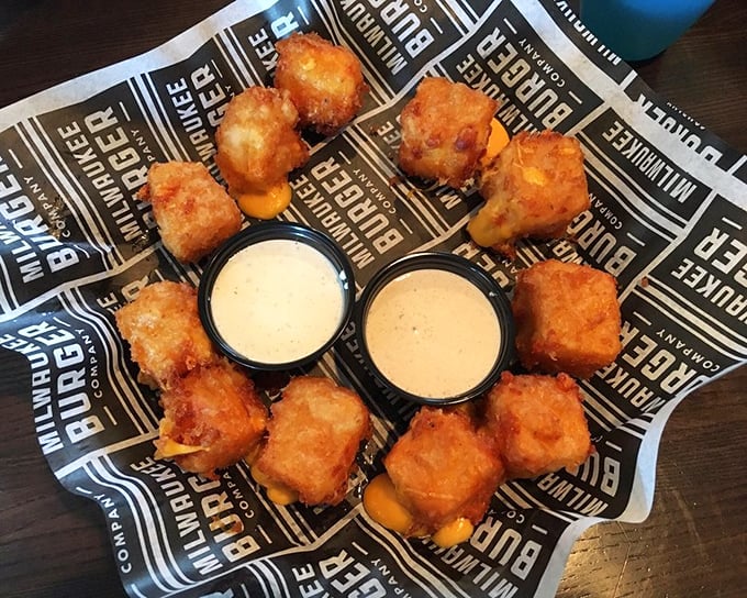 Fresh cheese curds glistening like little golden treasures, each one promising that perfect Wisconsin squeak.