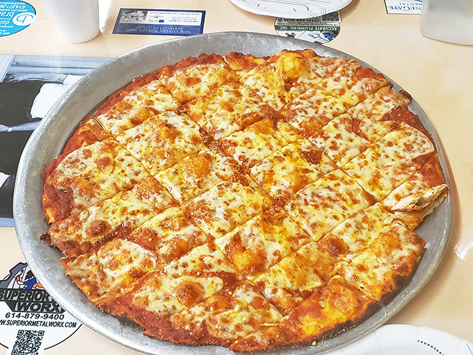 The party-cut squares of this cheese pizza aren't just a Midwestern tradition—they're an ingenious solution to the age-old debate of corner pieces versus center slices.