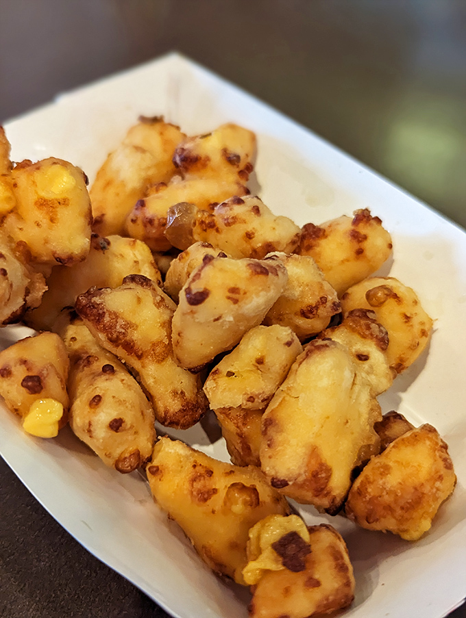 Wisconsin's unofficial state treasure—cheese curds that look like little nuggets of gold. Crispy outside, melty inside, happiness throughout.