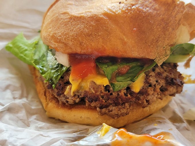 Every ingredient in perfect harmony – the melted cheese, the fresh lettuce, the perfectly seared patty. This is burger symphony in physical form.