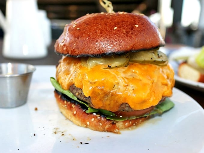 The burger that launched a thousand ships—or at least a thousand return visits—with cheese cascading down the sides like delicious lava.