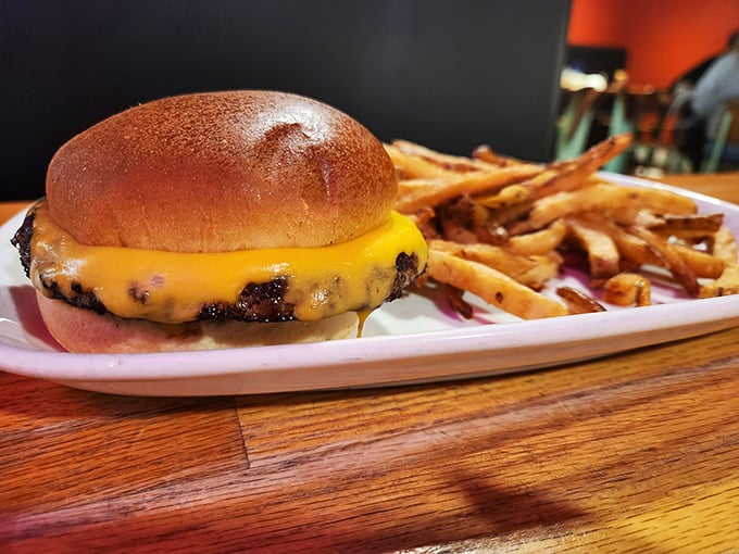 The perfect burger doesn't exi— wait, I stand corrected. Golden bun, melted cheese cascading down the sides, and hand-cut fries that demand attention.