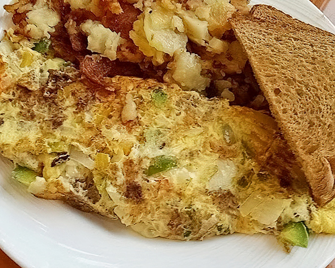 The perfect omelet doesn't exi— Oh wait, here it is! Stuffed with savory fillings and paired with golden home fries, this breakfast doesn't just satisfy—it conquers.