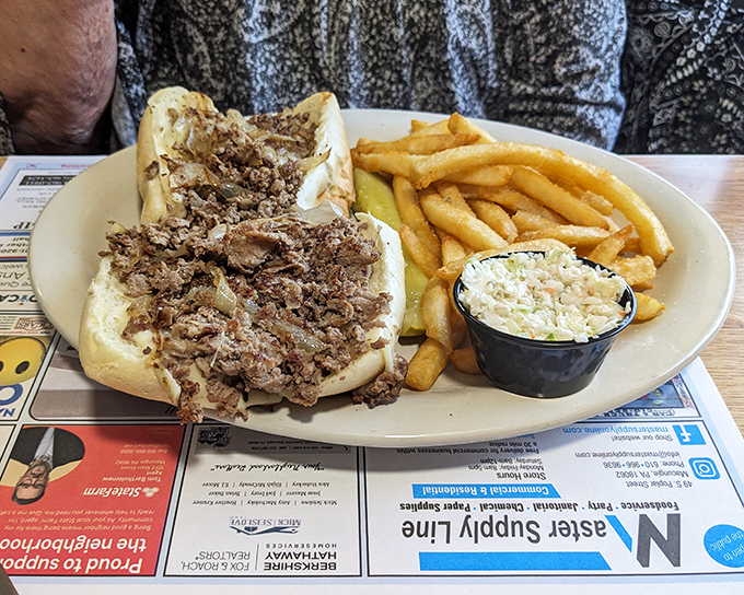Not all heroes wear capes – some come on a long roll with perfectly seasoned beef, melted cheese, and a side of crispy fries and coleslaw.