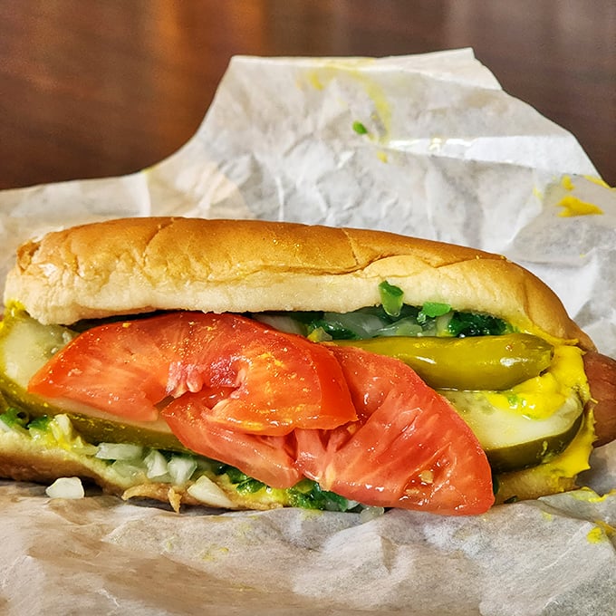 Chicago's hot dog tradition lives on with this beauty—fresh tomato slices, pickle spears, and mustard creating a symphony of flavors.