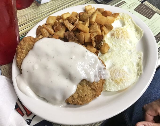 Country-fried steak smothered in gravy with home fries and eggs—the breakfast equivalent of a warm hug from someone who really means it.