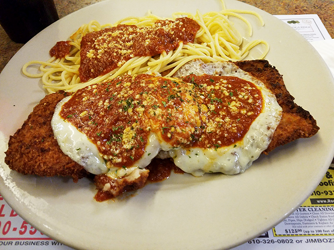 The chicken parmesan doesn't just hang over the edge of the plate—it declares itself the heavyweight champion of lunch options.