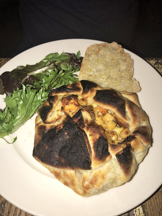Behold the chicken pot pie's sophisticated cousin—a rustic pastry bundle that's been to culinary finishing school. The char marks tell the flavor story.